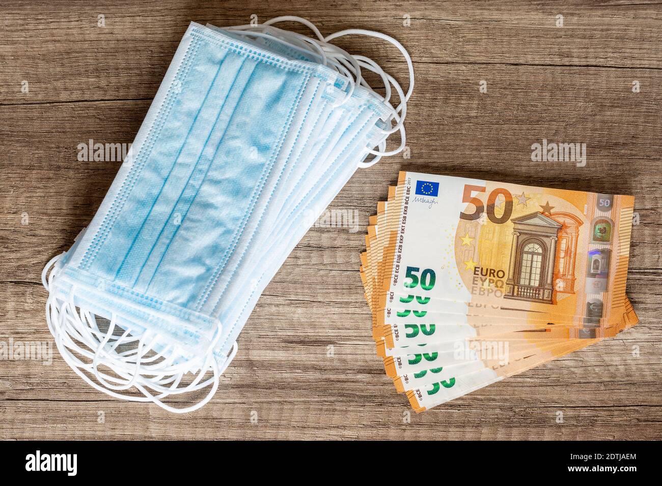 Surgical masks and euro banknotes Stock Photo - Alamy