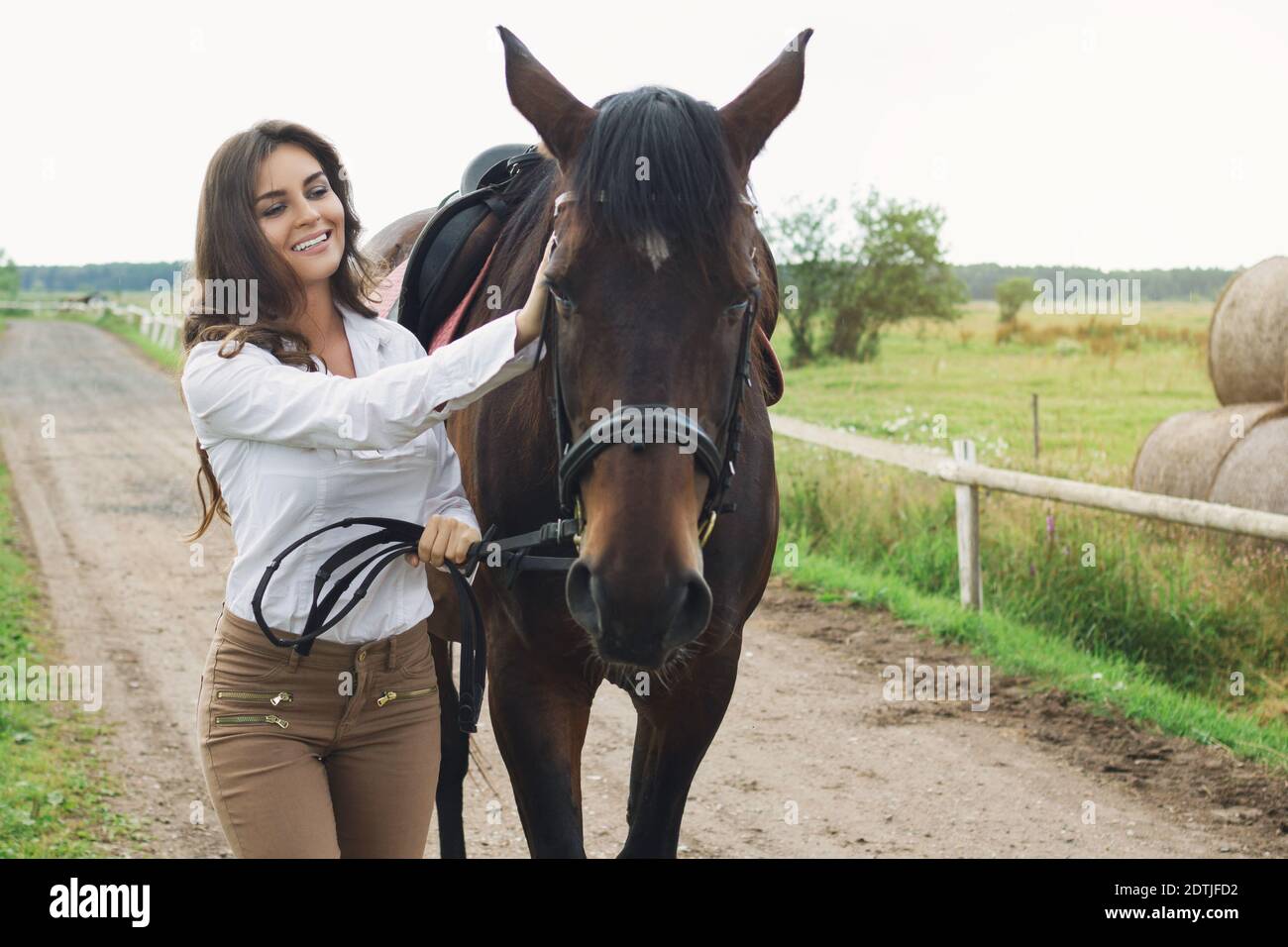 Young woman rider walking with her beautiful horse at countryside Stock ...