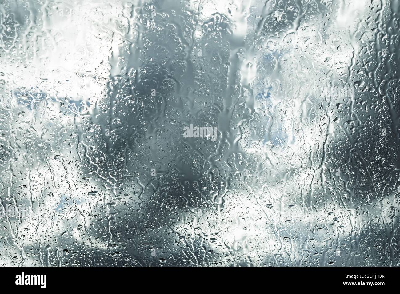 Wet car window. View through wet windshield on the cloudy sky Stock ...