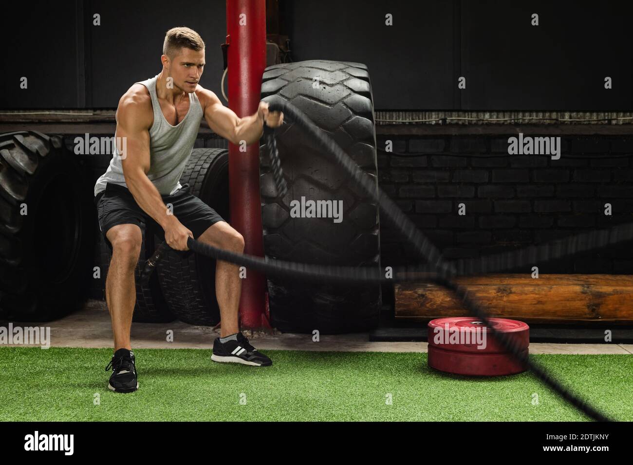 Battle rope exercises - Man during cross training workout Stock Photo ...