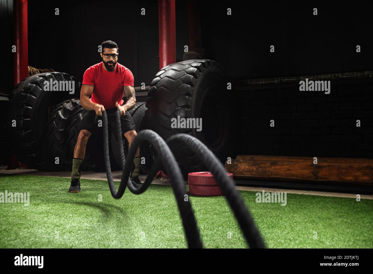 Battle rope exercises - Man during cross training workout Stock Photo ...