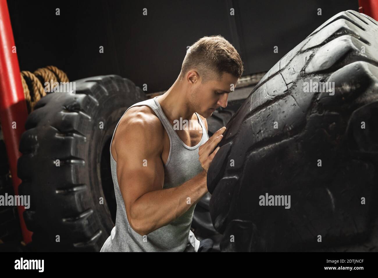 Tire flip exercise. Strong sportsman during his cross training workout ...