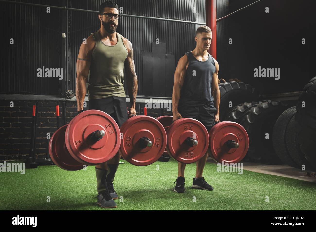 Two muscular men during competition in the farmer's walk exercise Stock ...