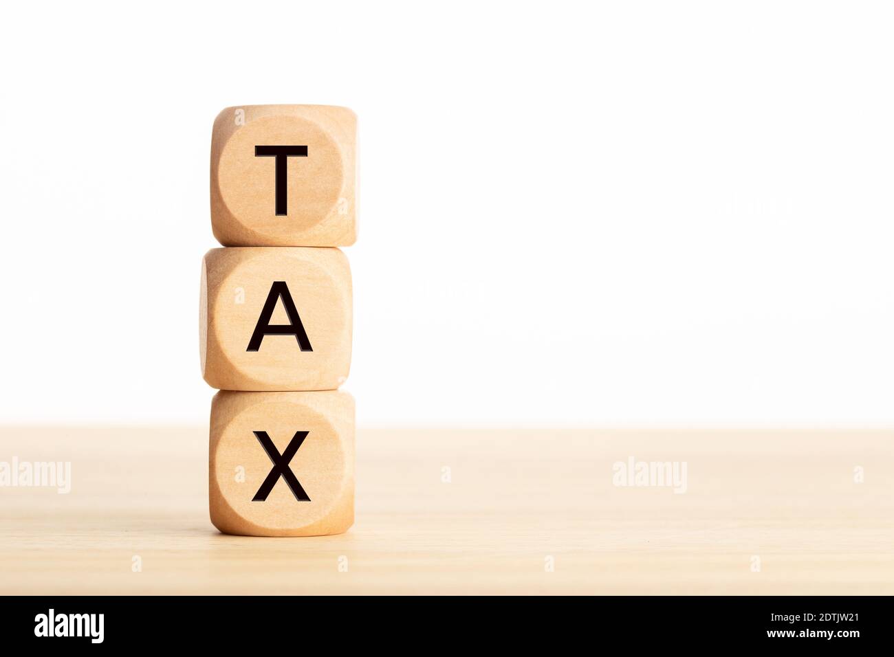 Tax word in wooden blocks on table. Taxation concept. White background ...