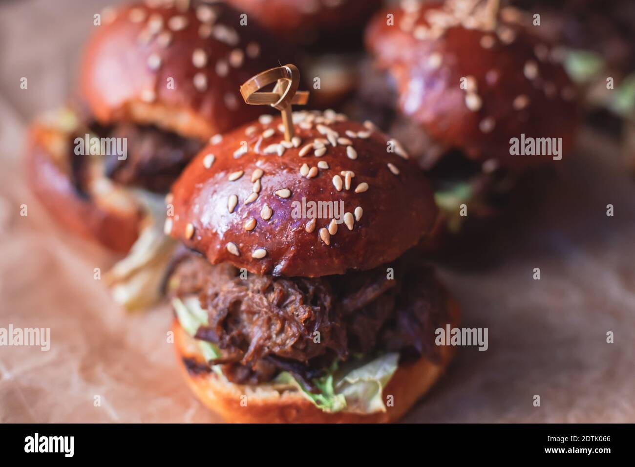 Burger mini burgers snacks on a wooden table with craft paper ...