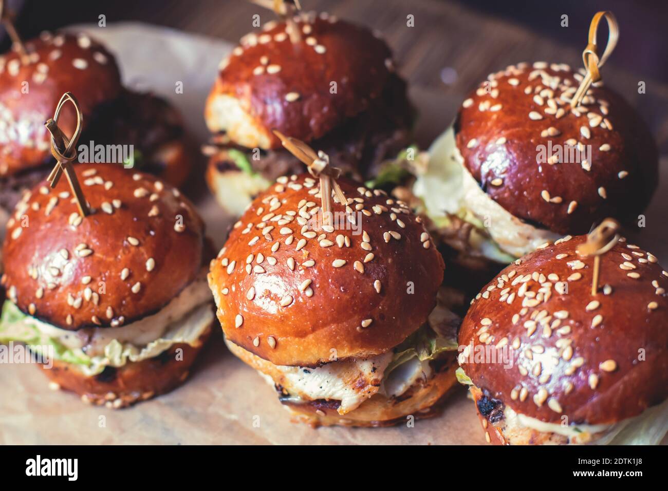 Burger mini burgers snacks on a wooden table with craft paper ...
