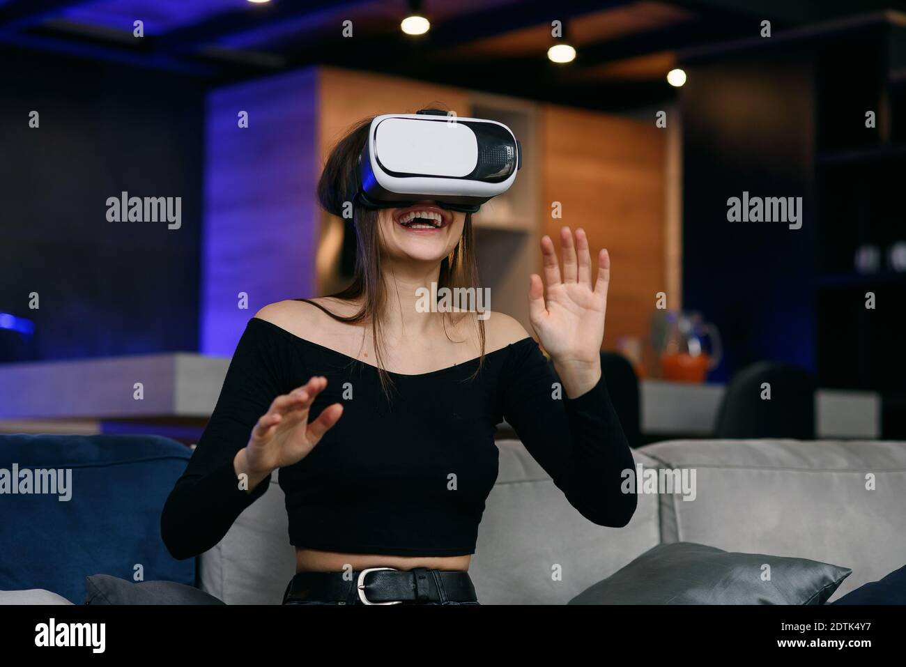 Virtual Reality concept. Excited beautiful adult girl uses VR Headset ...