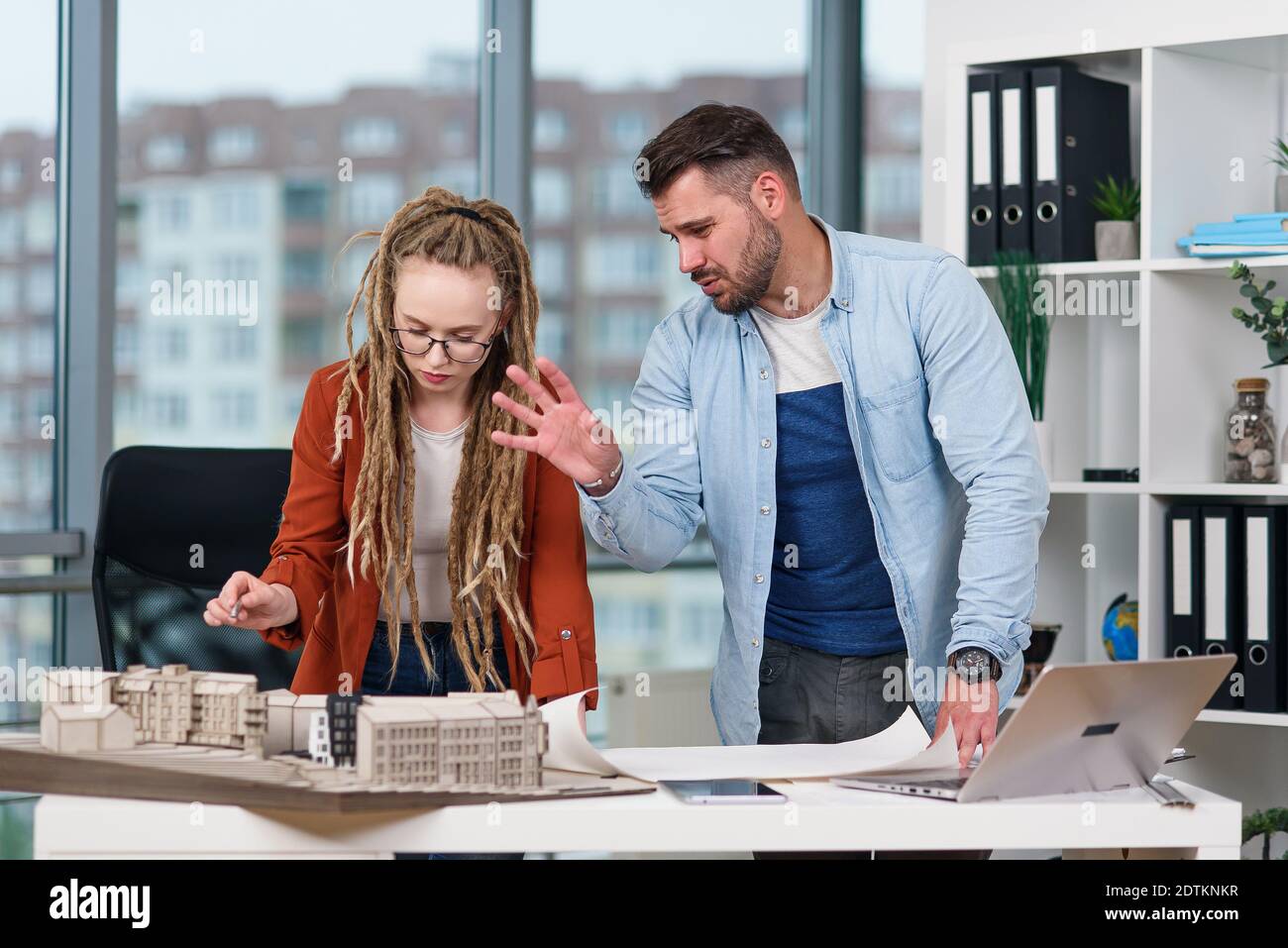 High-skilled creative male and female designers working with mock-up of ...