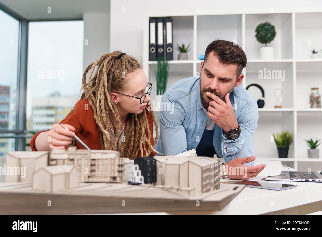 High-skilled creative male and female designers working with mock-up of ...
