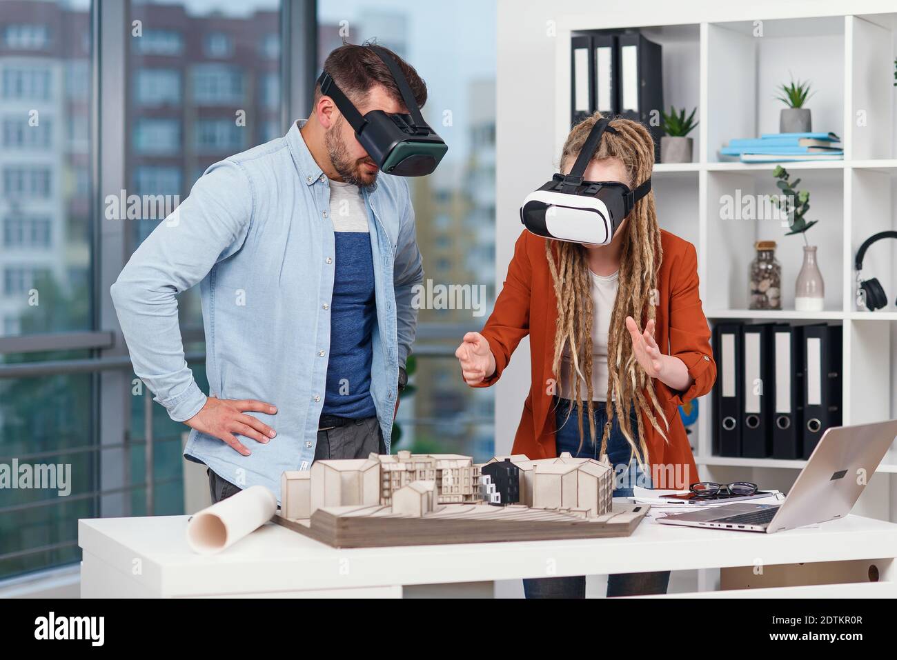 Professional architect working at office desk and wearing a VR headset ...