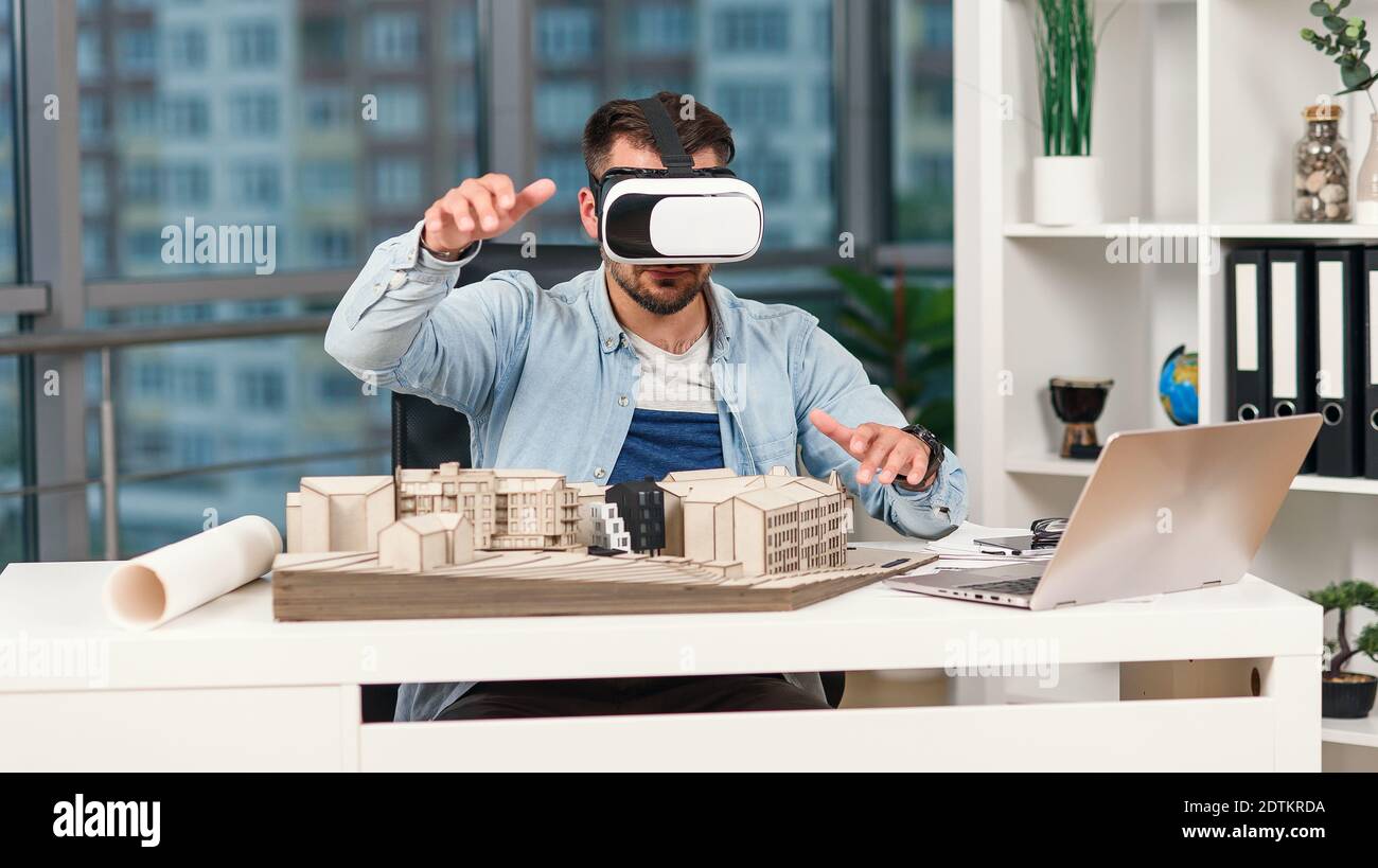 Skillful man as an architect reviewing architectural project with vr ...