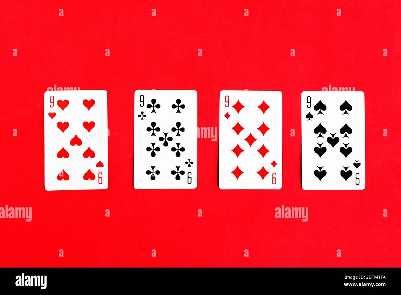 Poker quads playing card, red background Stock Photo - Alamy