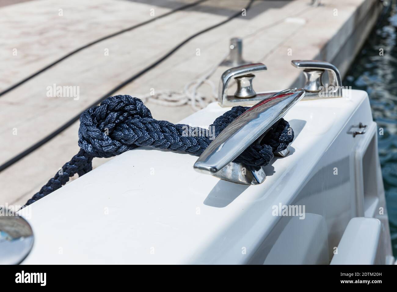 Detail of an anchor rope on a yacht. Mooring knot on the boat close up ...