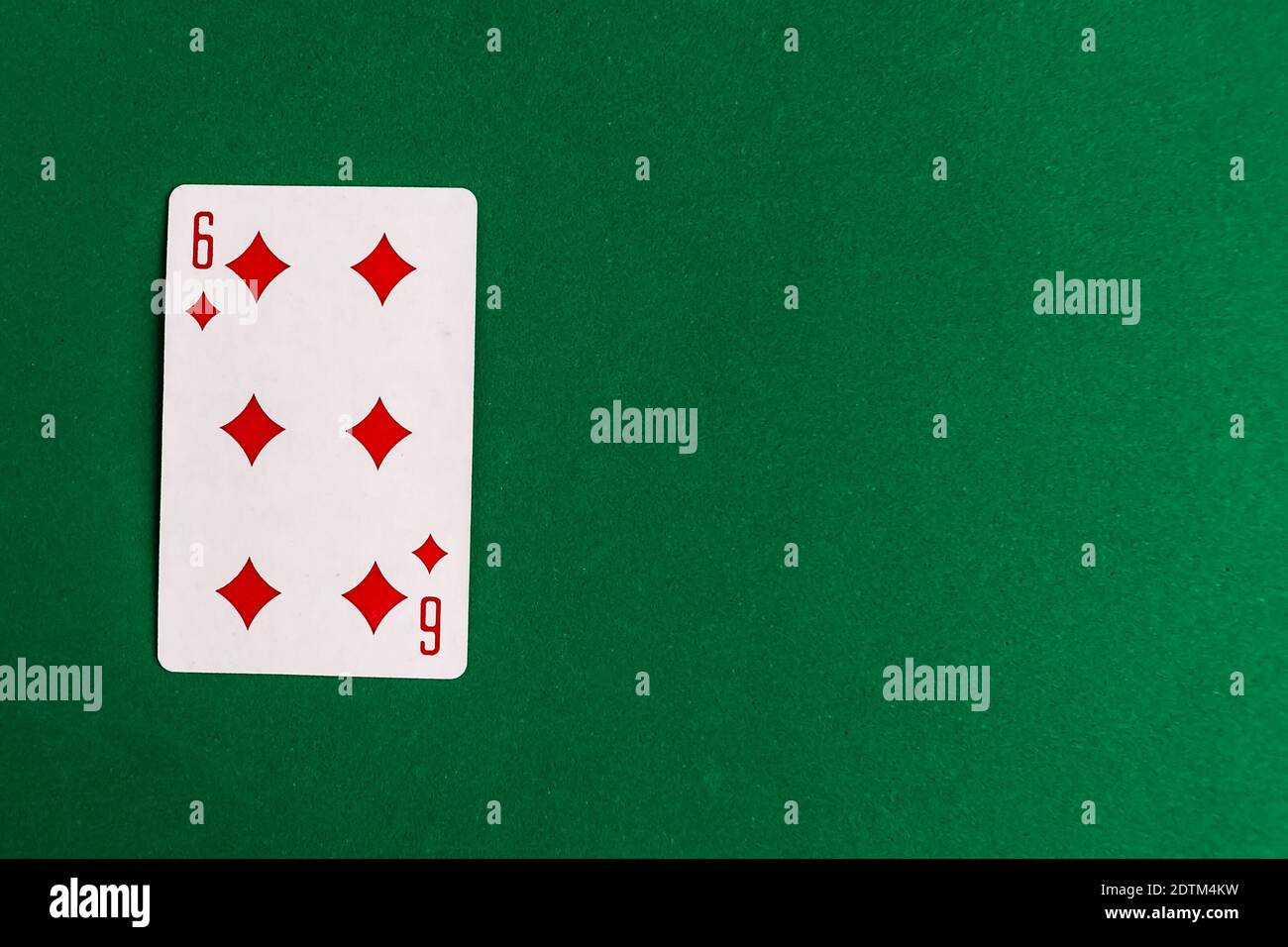Six of Diamonds playing card, green background, copy space Stock Photo ...