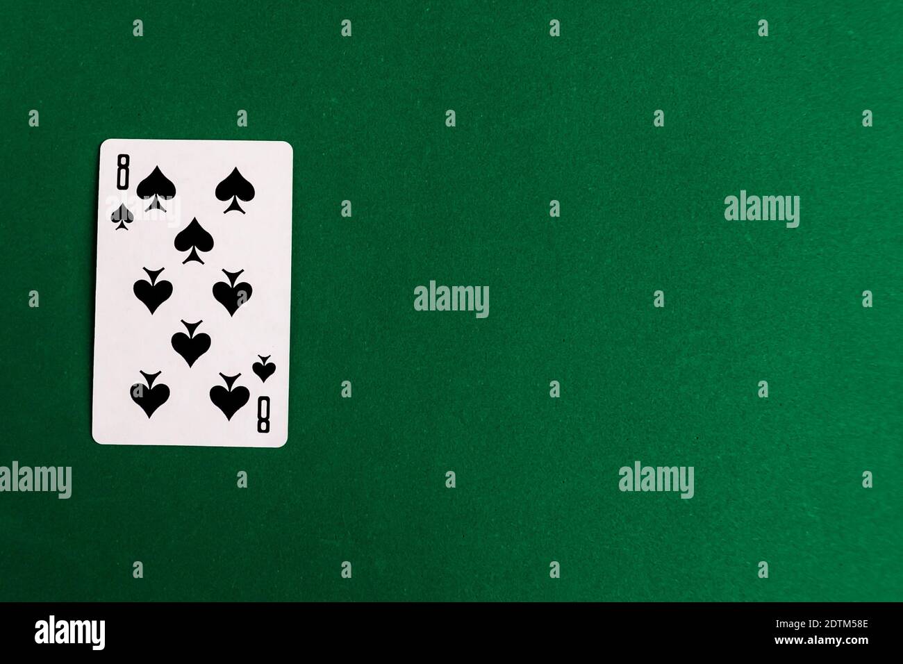Eight of Spades playing card, green background, copy space Stock Photo ...
