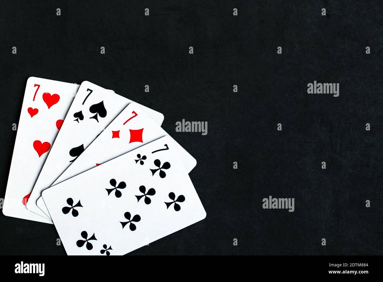 Poker quads playing card, black background Stock Photo - Alamy
