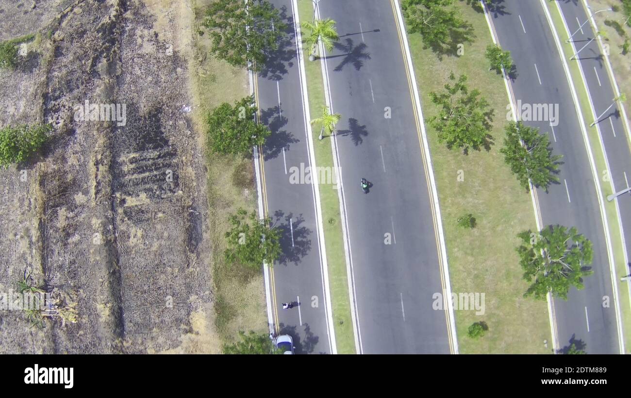 An aerial shot of a paved asphalt road with trees on sides Stock Photo ...