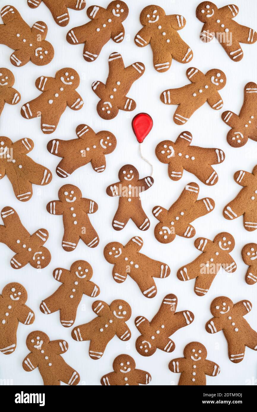 Gingerbread Men biscuits with a red balloon on white background ...