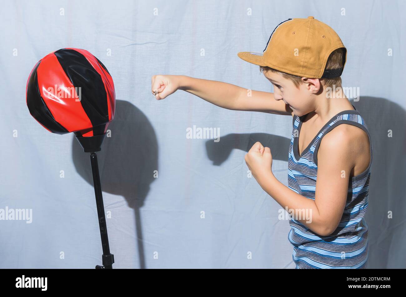 Boxing kid boy punching bag hi-res stock photography and images - Alamy