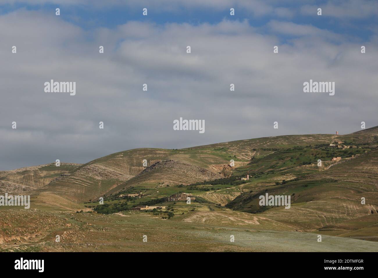 A beautiful cloudscape over rolling hills ay daytime Stock Photo - Alamy