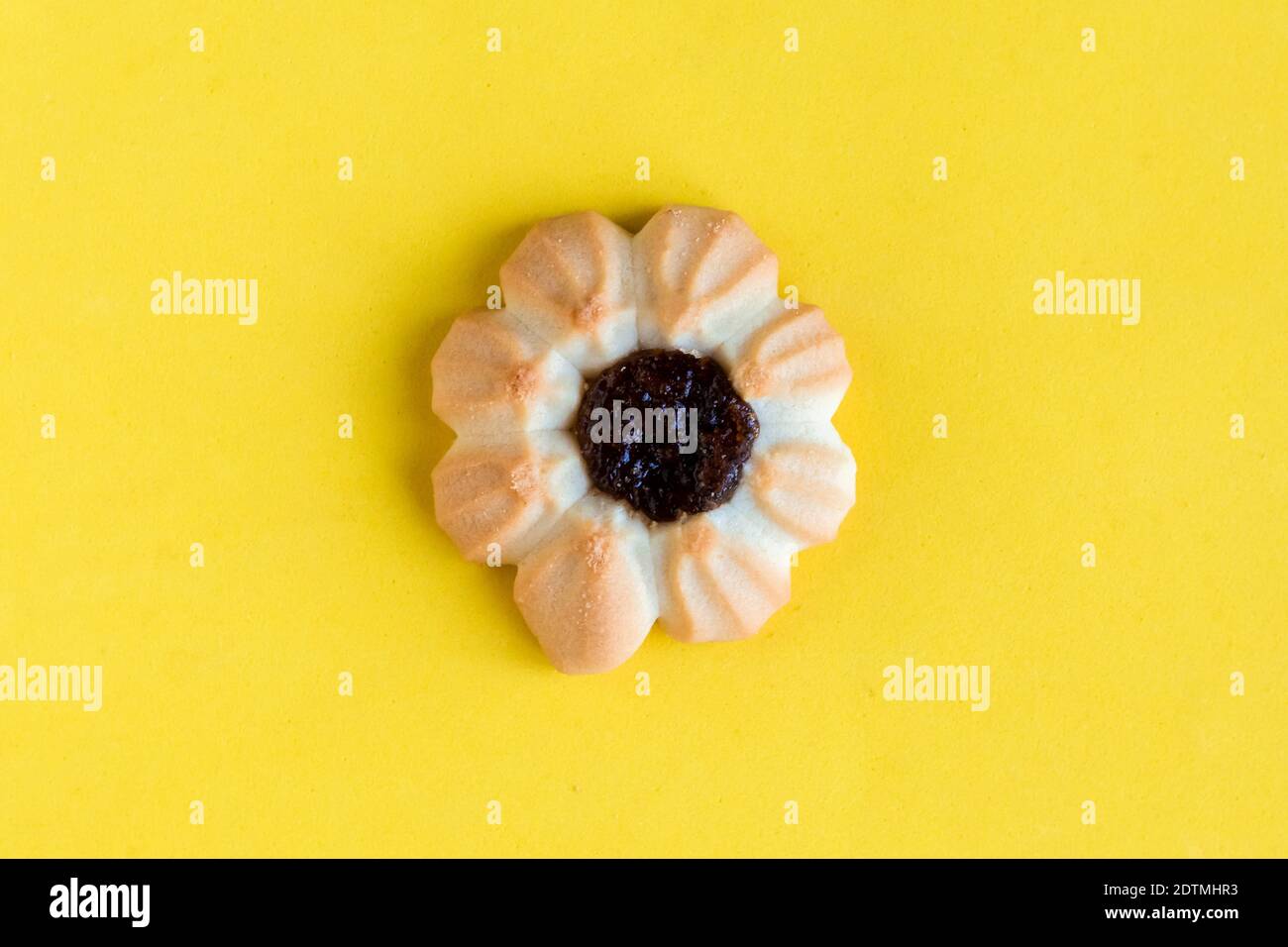 Tasty homemade cookie isolated on bright yellow background, minimal ...