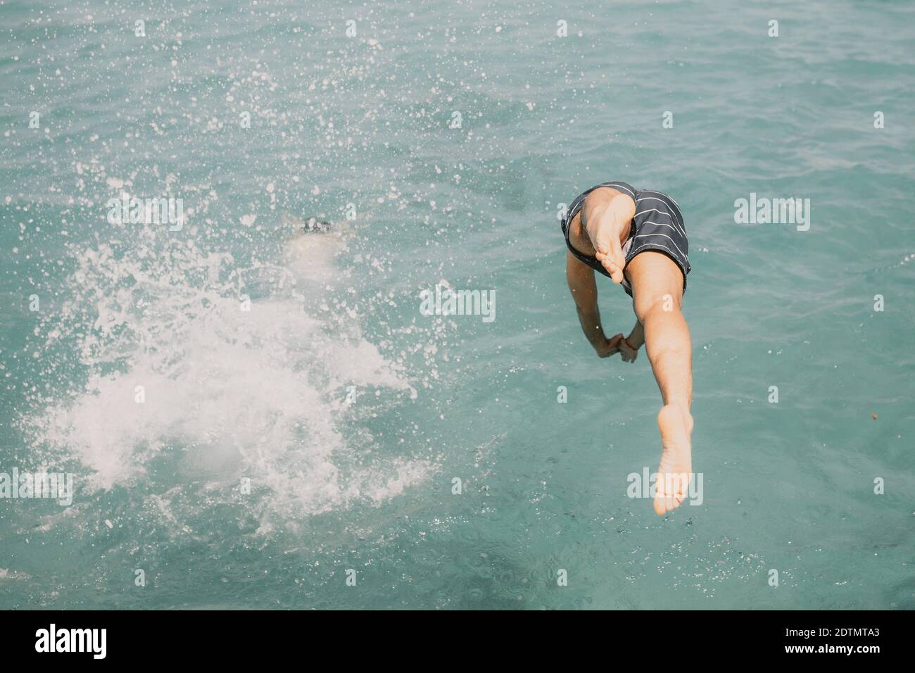 Jumping into the water Stock Photo - Alamy