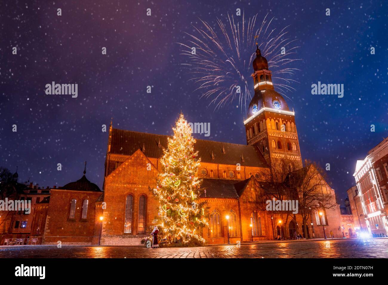 A low angle shot of the colorful fireworks on the church on a starry ...
