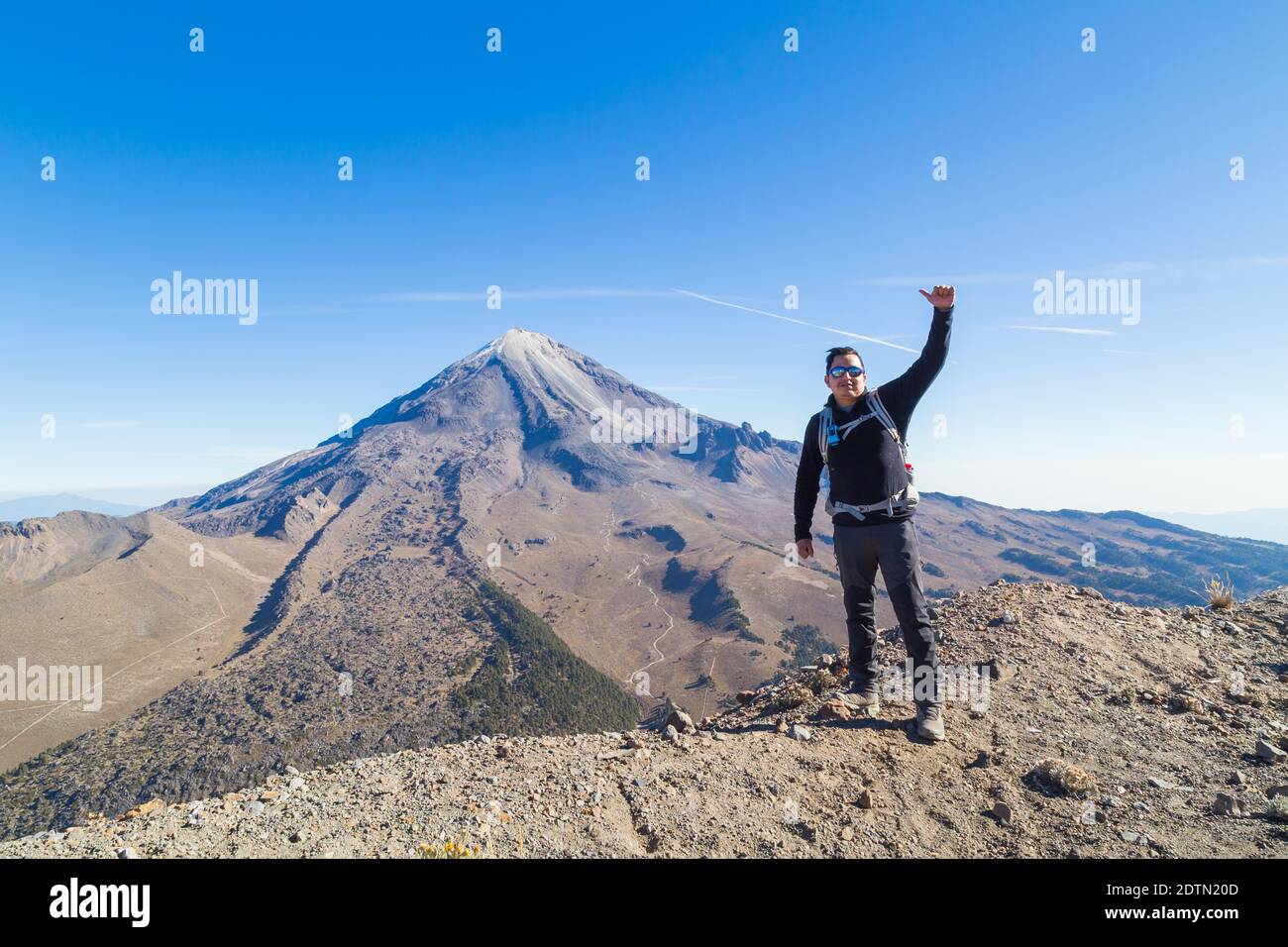 A beautiful shot of a male standing in Pico de Orizaba Volcano in ...