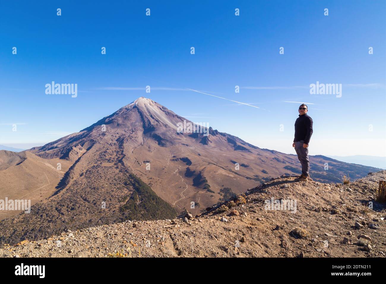 A beautiful shot of a male standing in Pico de Orizaba Volcano in ...