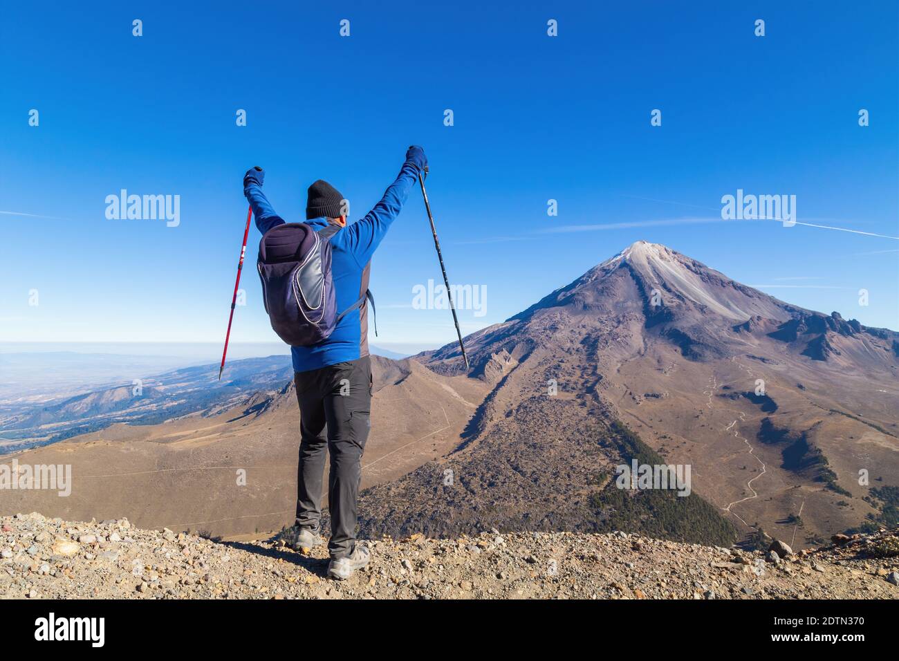 A beautiful shot of a male holding a hiking stick on both hands in Pico ...