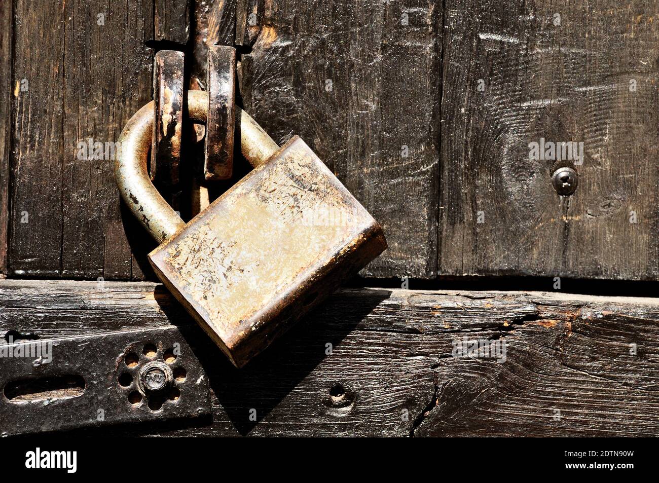 Old wooden door locked with padlock Stock Photo - Alamy