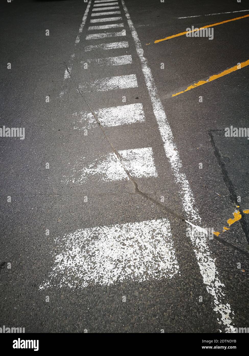 A high angle shot of the pedestrian and parking lines in a parking lot ...