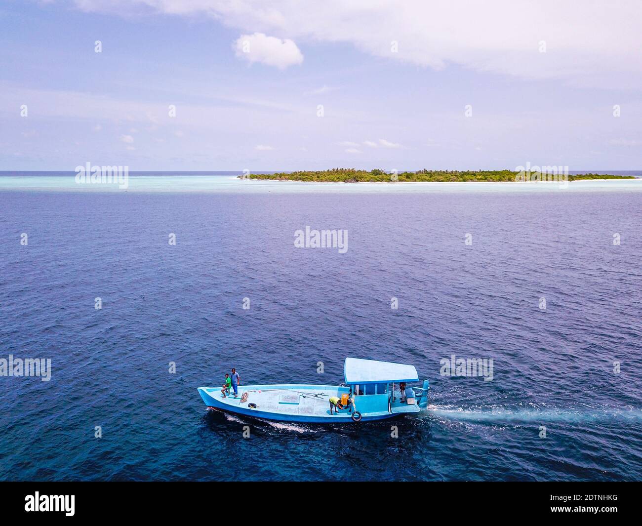 Traditional boat (dhoni) reef fishing near an island in the Maldives ...