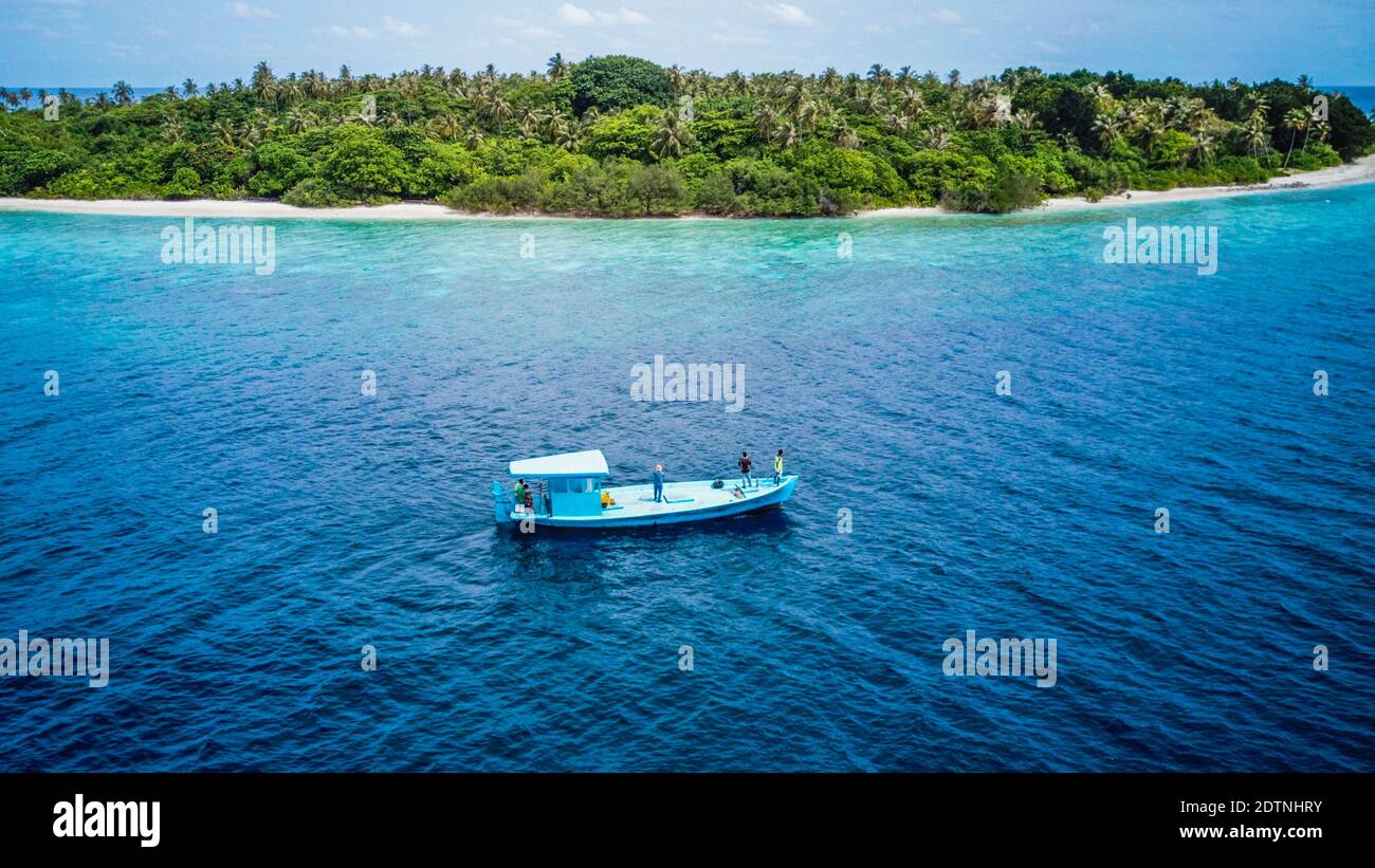 Traditional boat (dhoni) reef fishing near an island in the Maldives ...