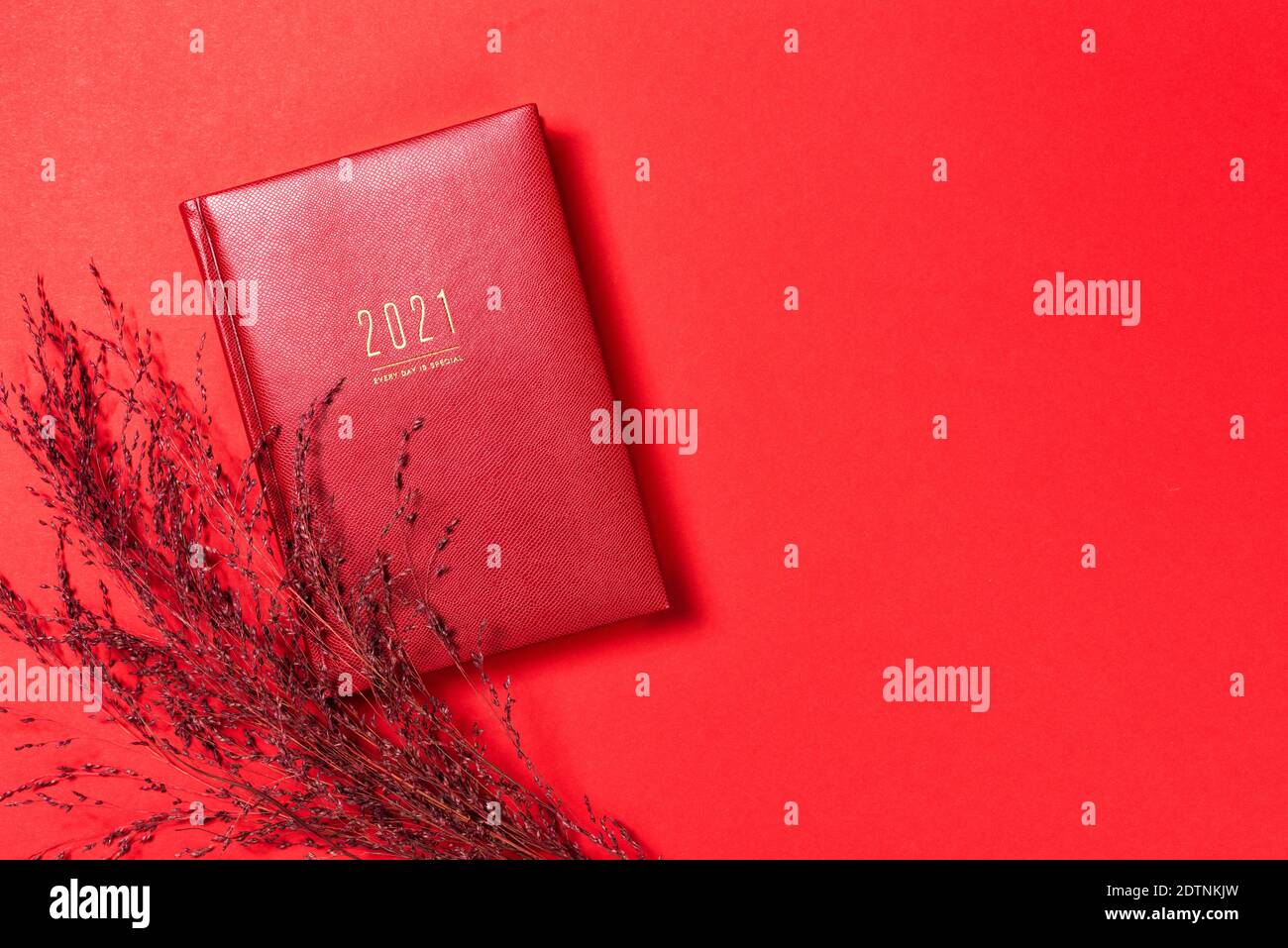 Red diary planner with 2021 year calendar and. Office workspace with ...