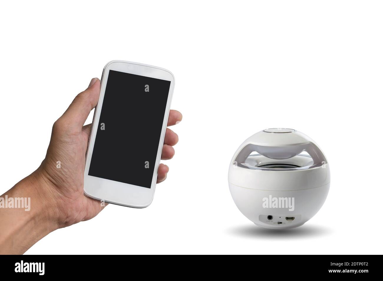 Hand holding smart phone with bluetooth speaker isolated on white ...