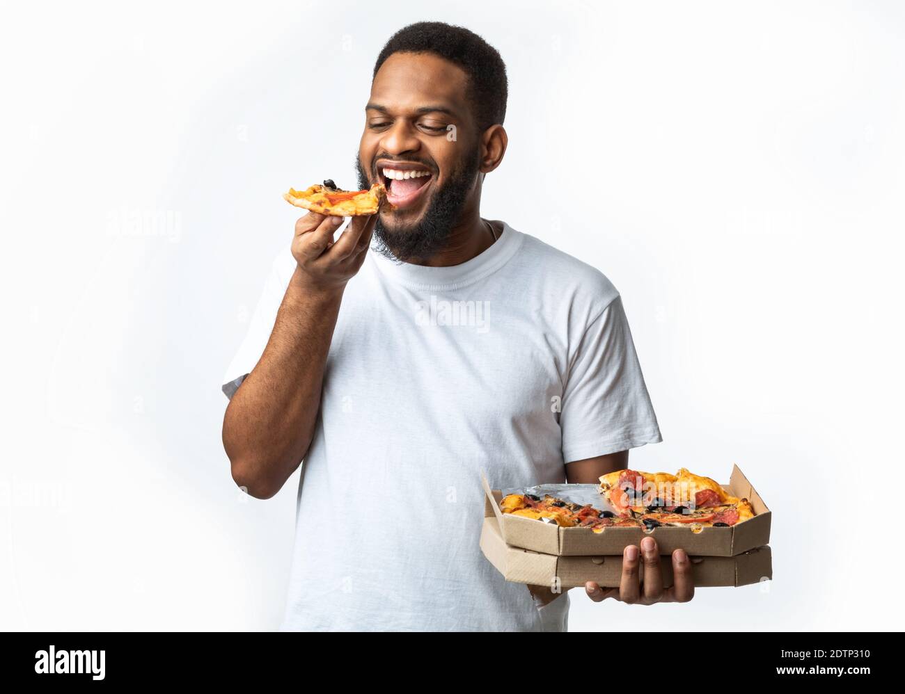 Hungry Black Guy Eating Pizza Holding Box Standing In Studio Stock ...