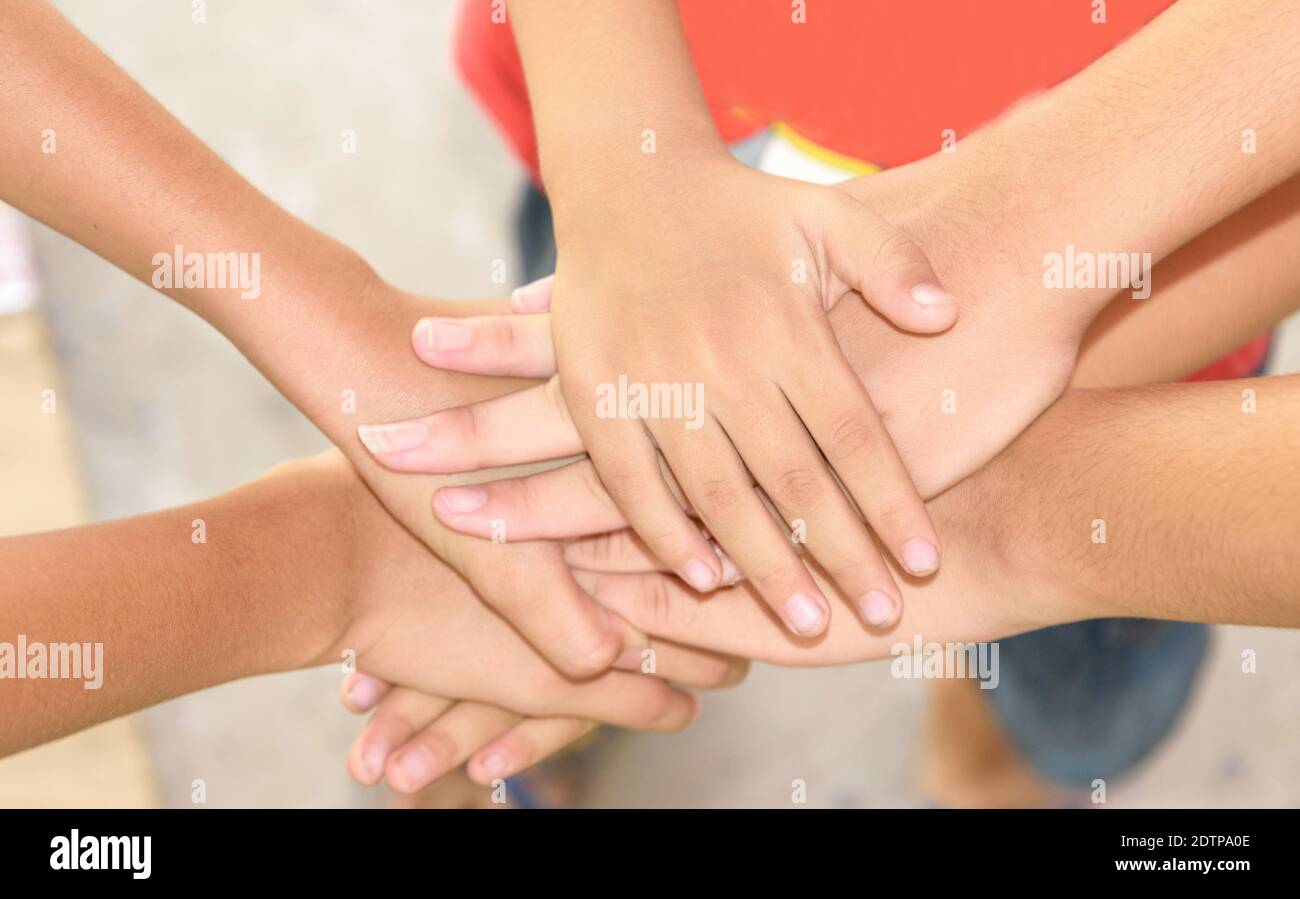 To join hands to show unity and team spirit Stock Photo - Alamy