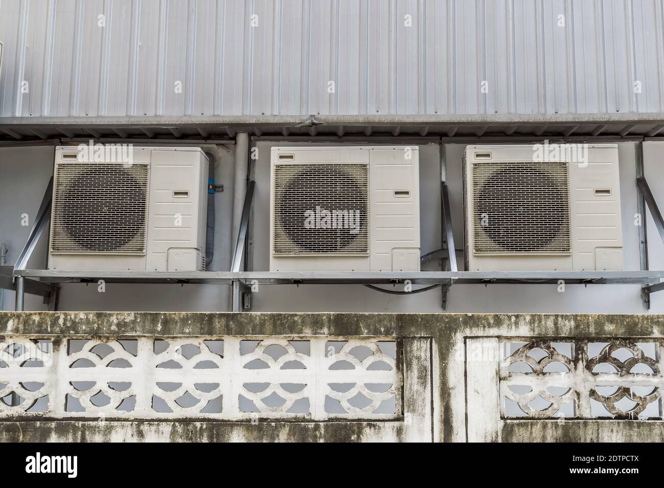 Air compressors hung on the outside wall of the building Stock Photo ...
