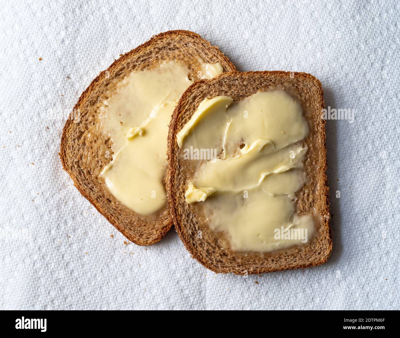 Overhead view of two slices of lightly toasted wheat bread with ...