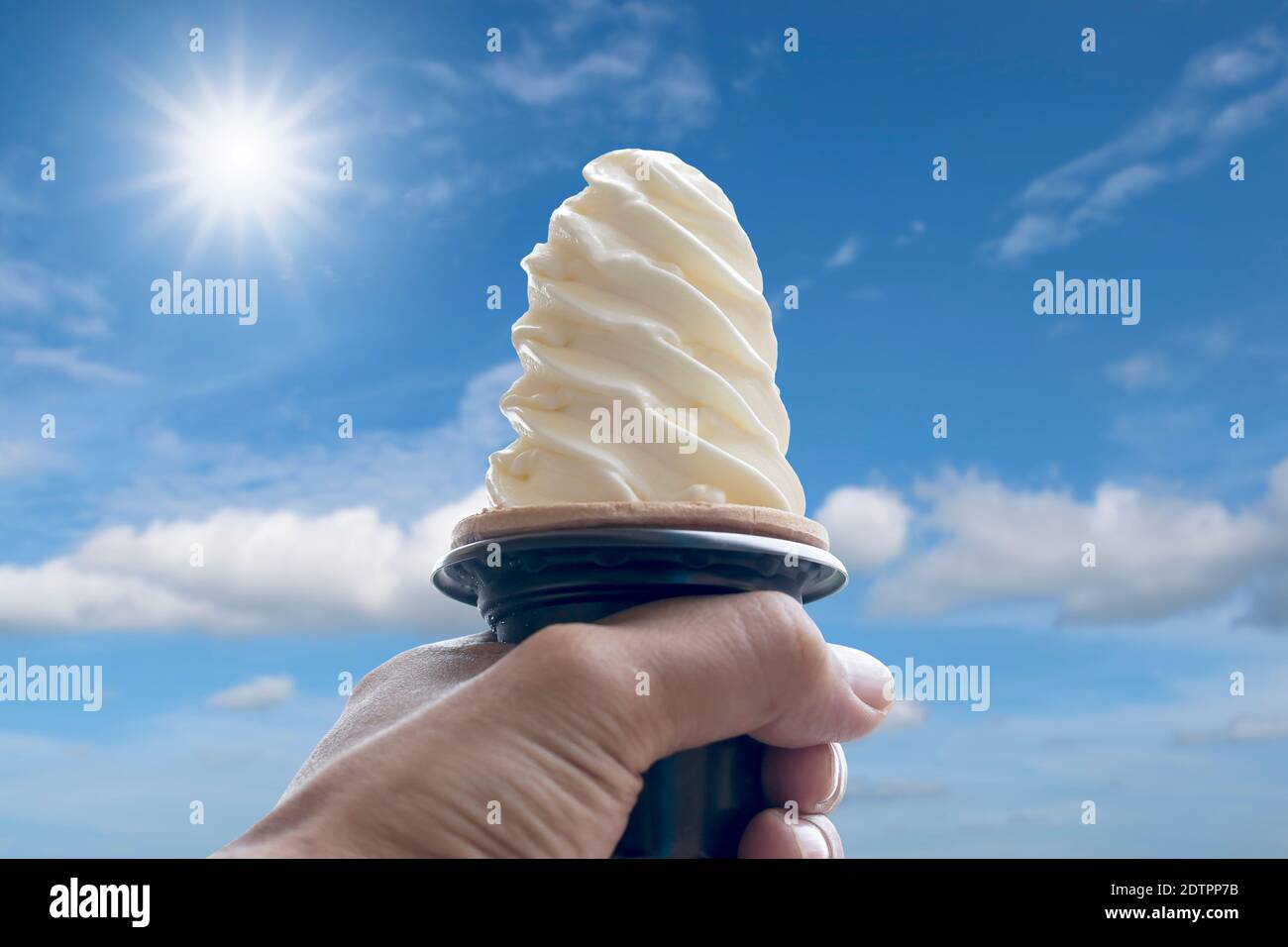 Hand holding ice cream cone on the sky and sunlight background Stock ...