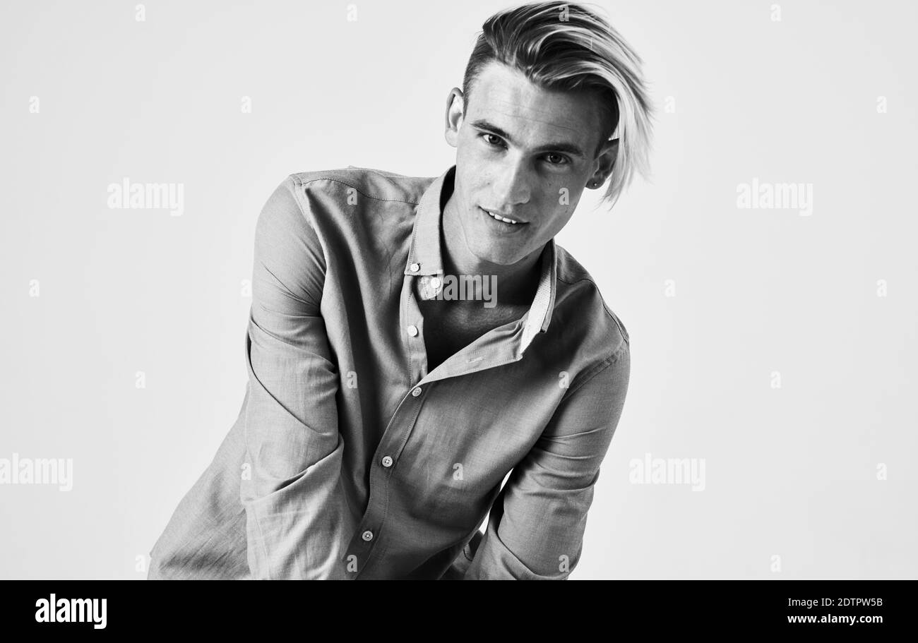 beautiful gentleman in a shirt on a light background gray photograph ...