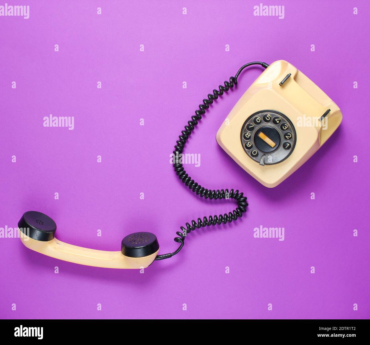 Retro rotary phone with handset on purple background. Top view Stock ...