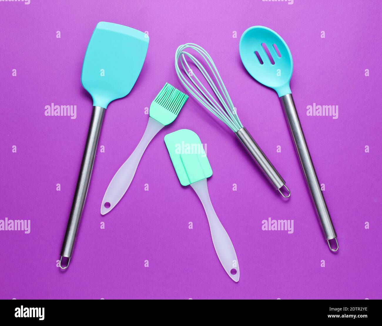 Silicone tools with metal handles for cooking on purple background ...