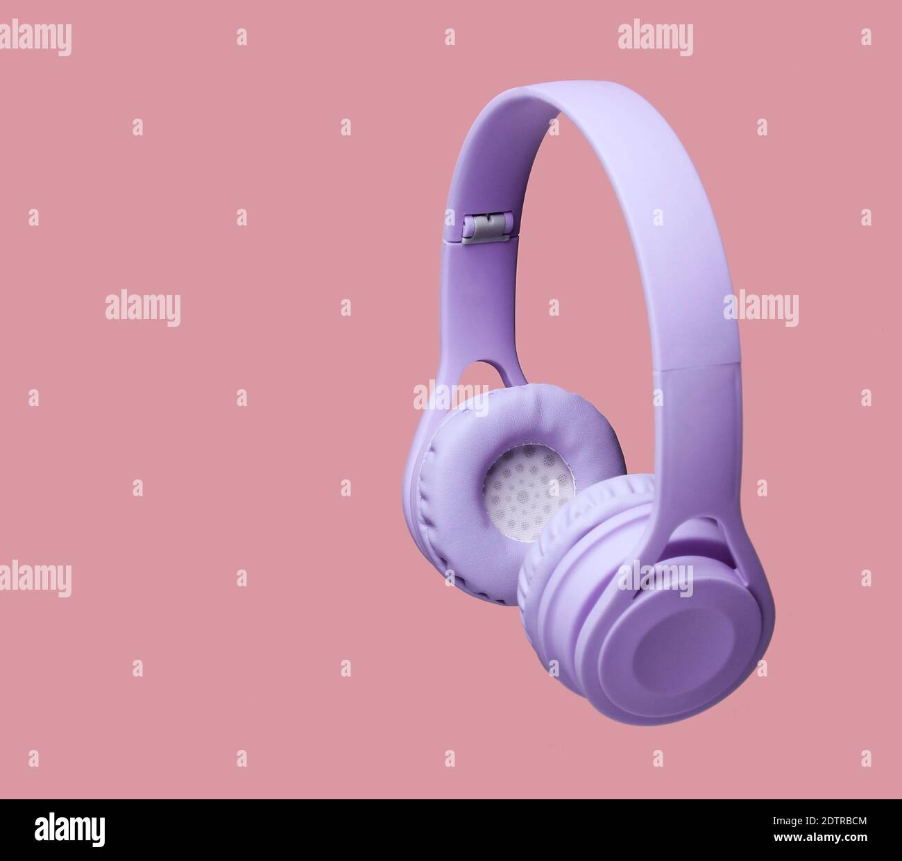 3D surround photo purple wireless headphones on coral color background ...