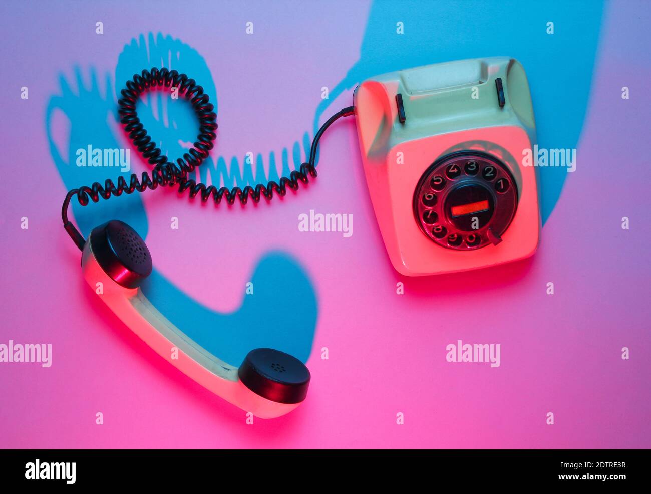 Vintage rotary phone. Retro wave, pink blue neon light, ultraviolet ...