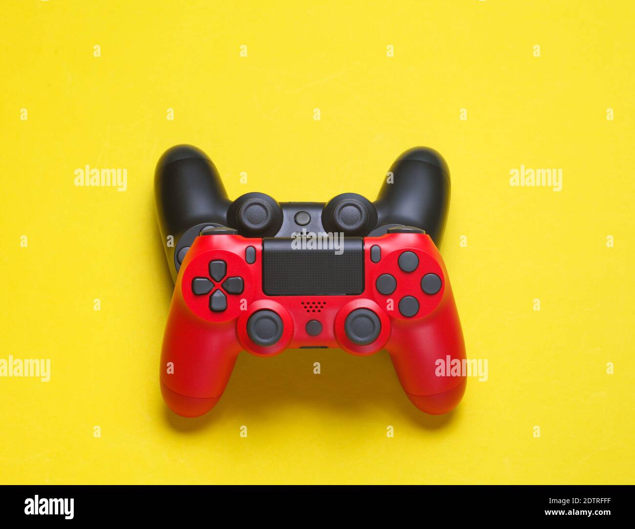 Two joysticks on a yellow background. top view Stock Photo - Alamy