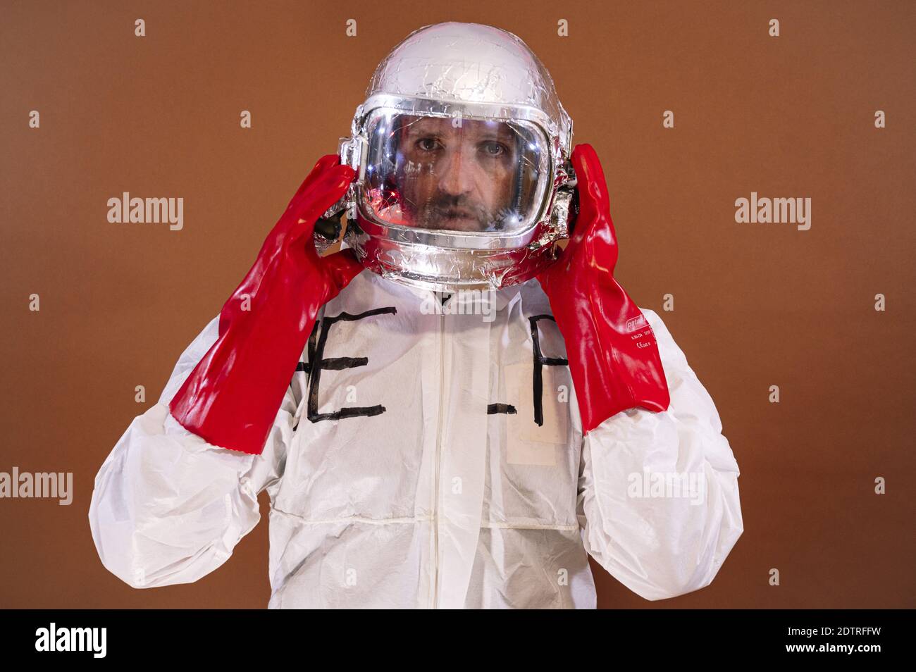 A man wearing Coronavirus protection coverall gloves and shield Stock ...