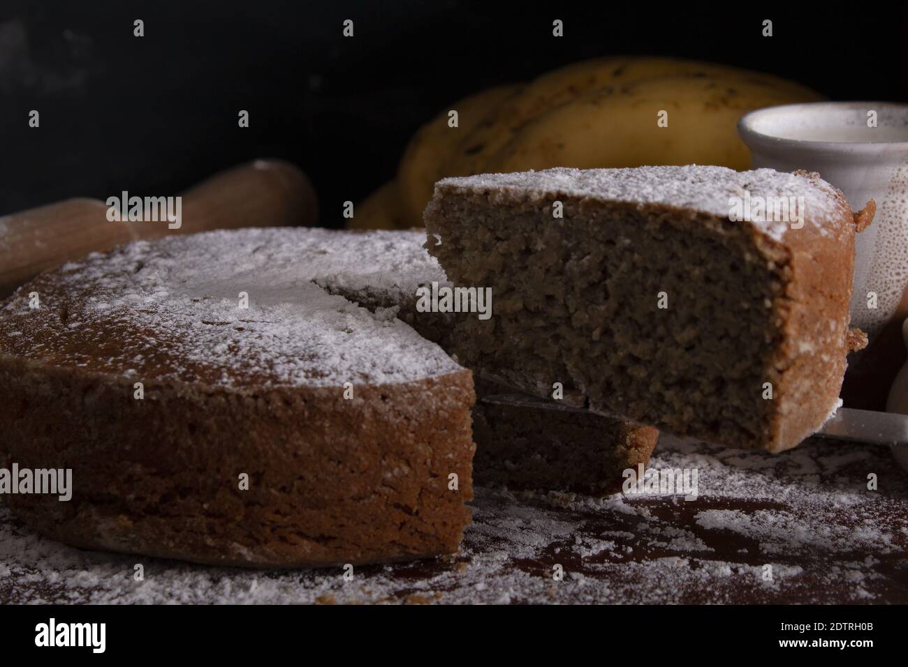 A homemade baked round banana cake with sugar powder Stock Photo - Alamy