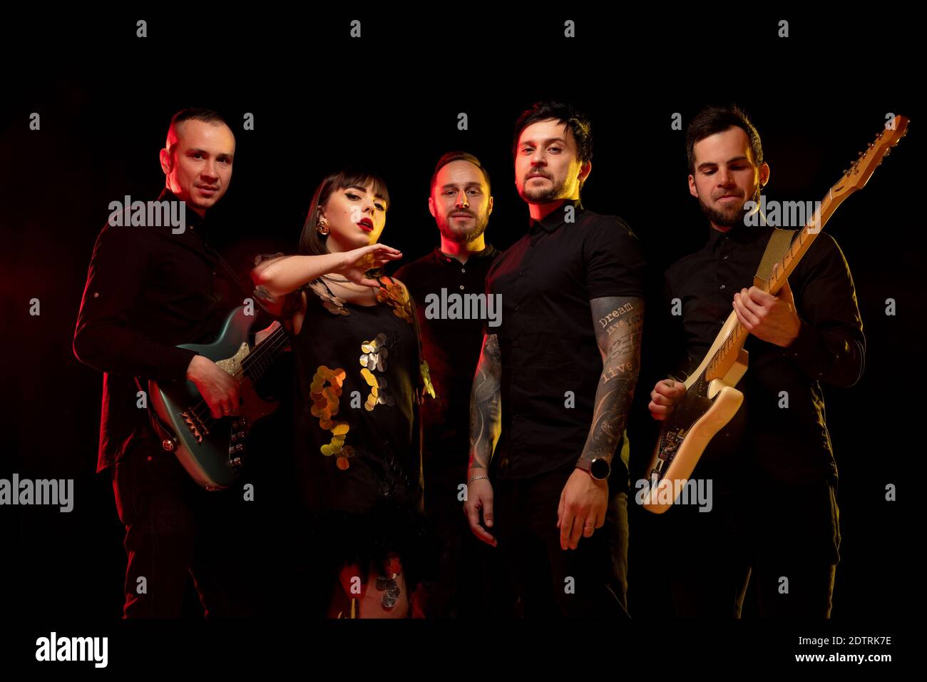 Stylish. Musician's band portrait isolated on dark studio background in ...